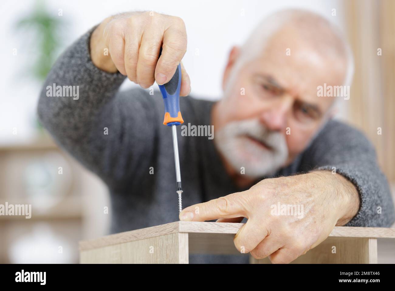 mature man using a screwdriver Stock Photo - Alamy