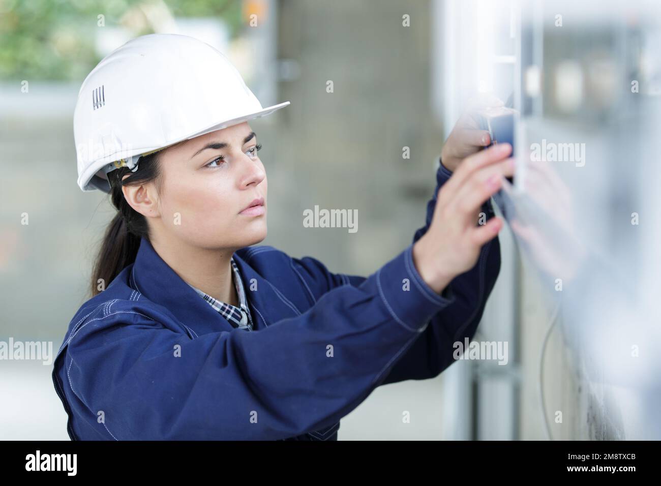 young woman installing window at construction site Stock Photo - Alamy