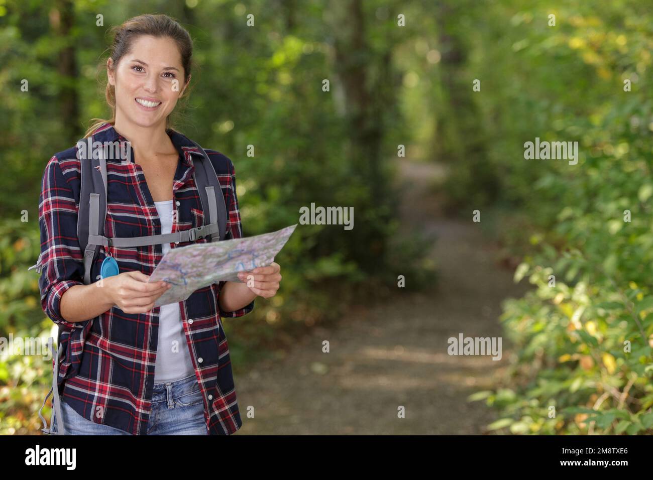smiling healthy woman hiker holding map Stock Photo - Alamy