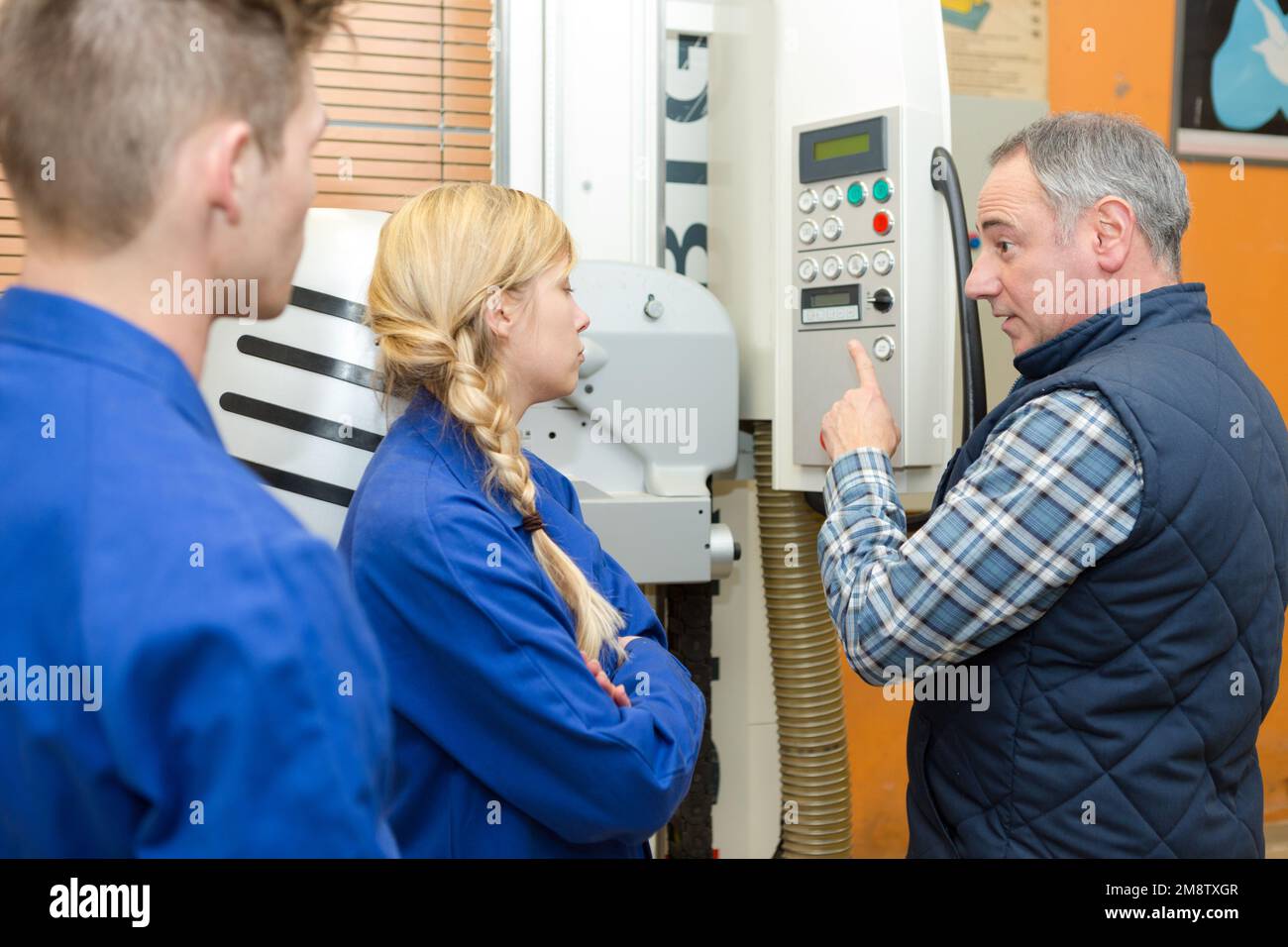 Factory workers operating equipment hi-res stock photography and images ...