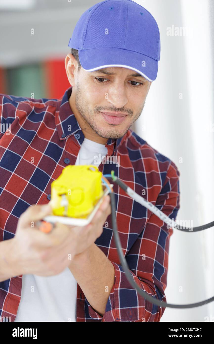 male electrician checking wiring in a junction box Stock Photo - Alamy