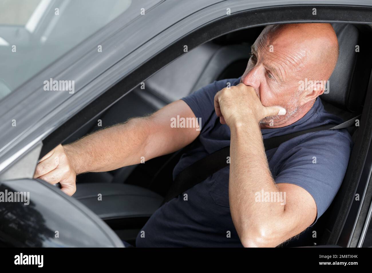 bored mature male driver behind the wheel Stock Photo - Alamy