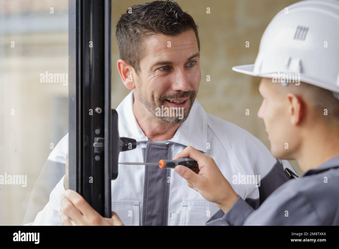 two men professional labours with finished pvc Stock Photo - Alamy