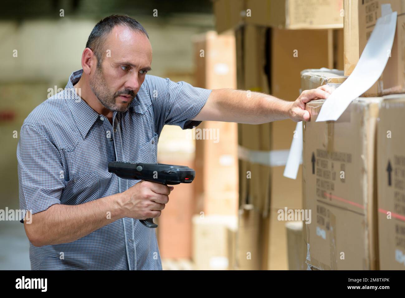 man worker handling barcode scanner in warehouse factory Stock Photo ...