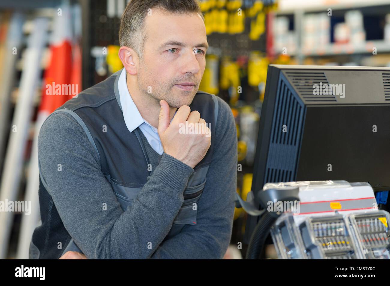 manual worker using a laptop in a warehouse Stock Photo - Alamy