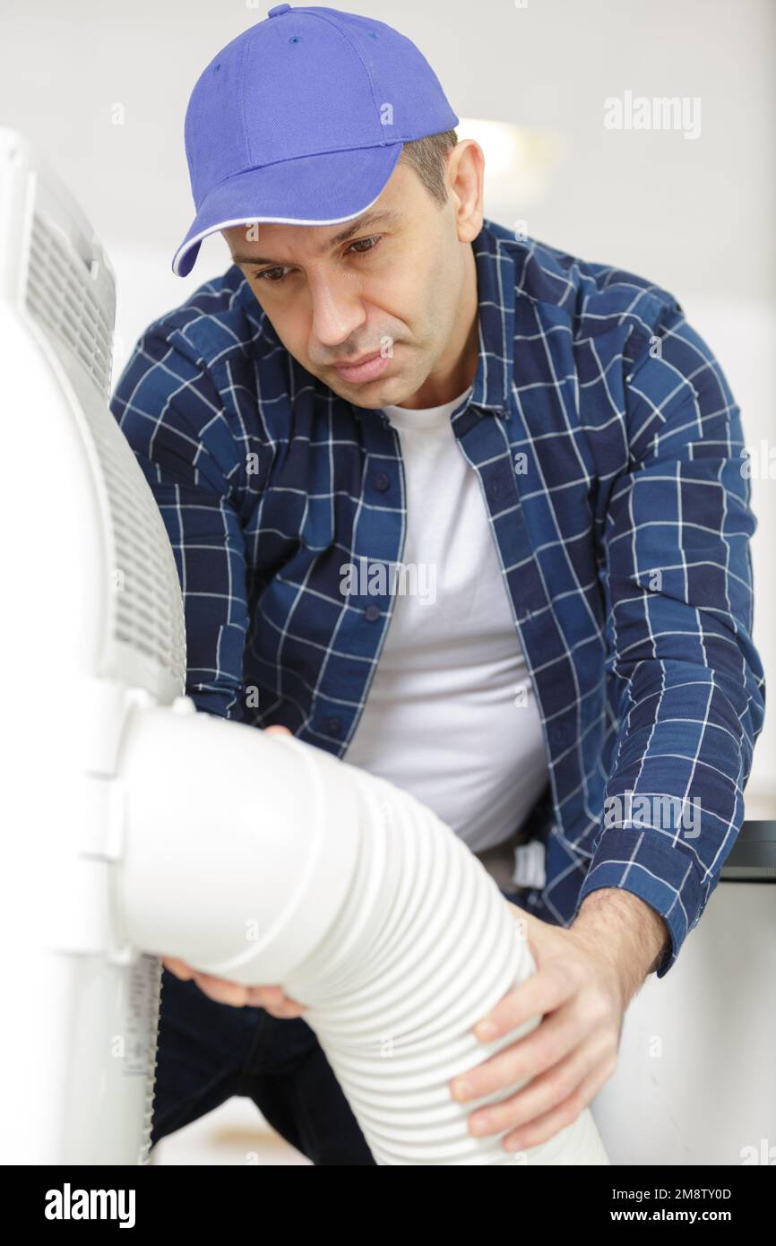 builder installer of ventilation with tools in hands Stock Photo - Alamy