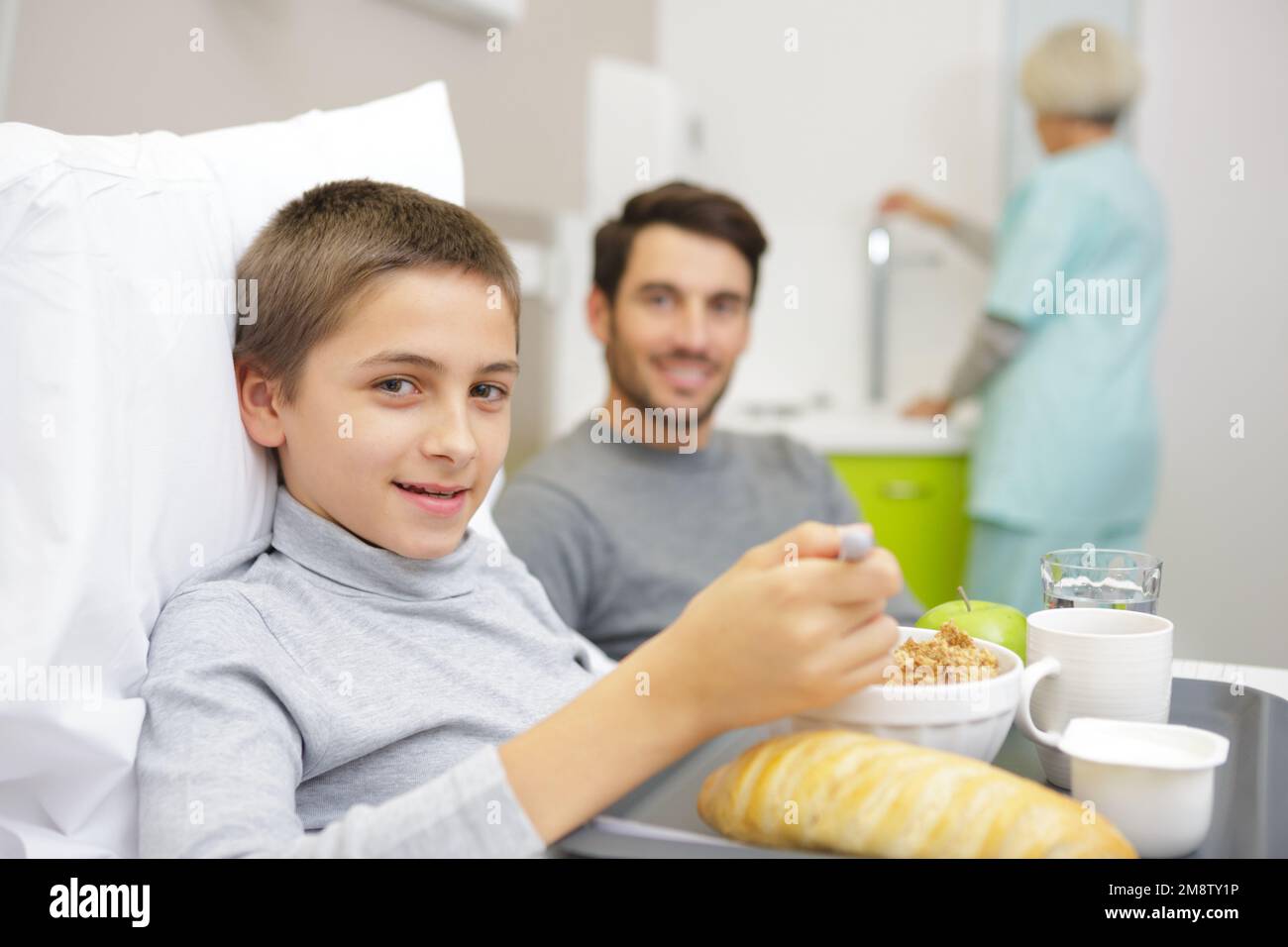 smiling caregiver visiting happy sick child in the health center Stock ...