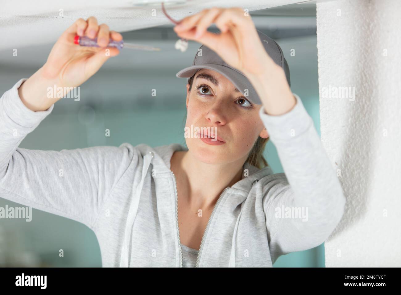 asian woman changing light bulb Stock Photo - Alamy