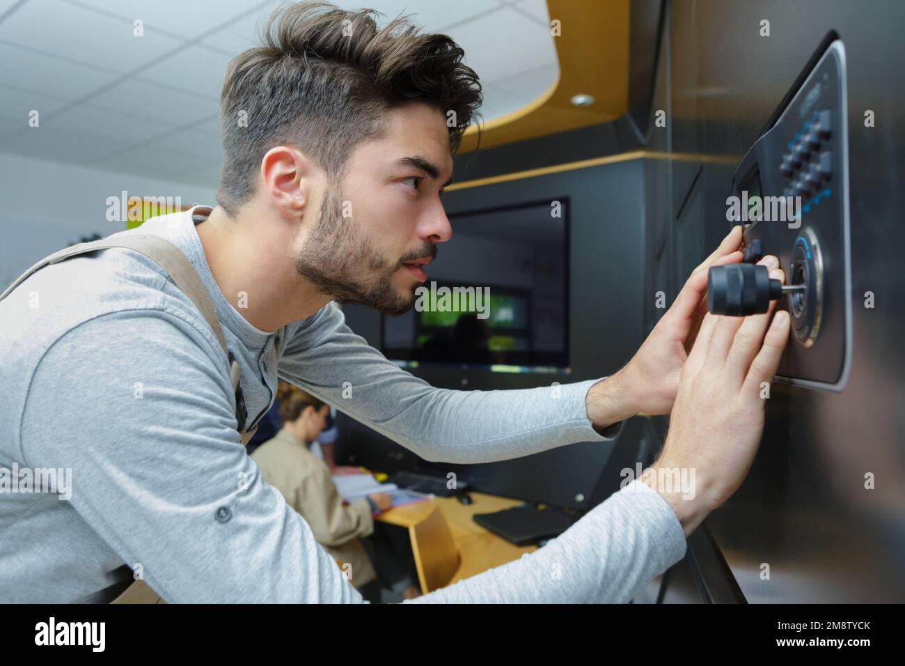 young male worker using electronic keypad Stock Photo - Alamy