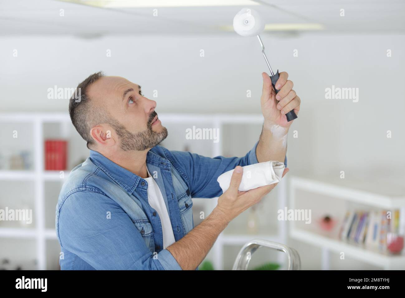 Worker paints ceiling hi-res stock photography and images - Alamy