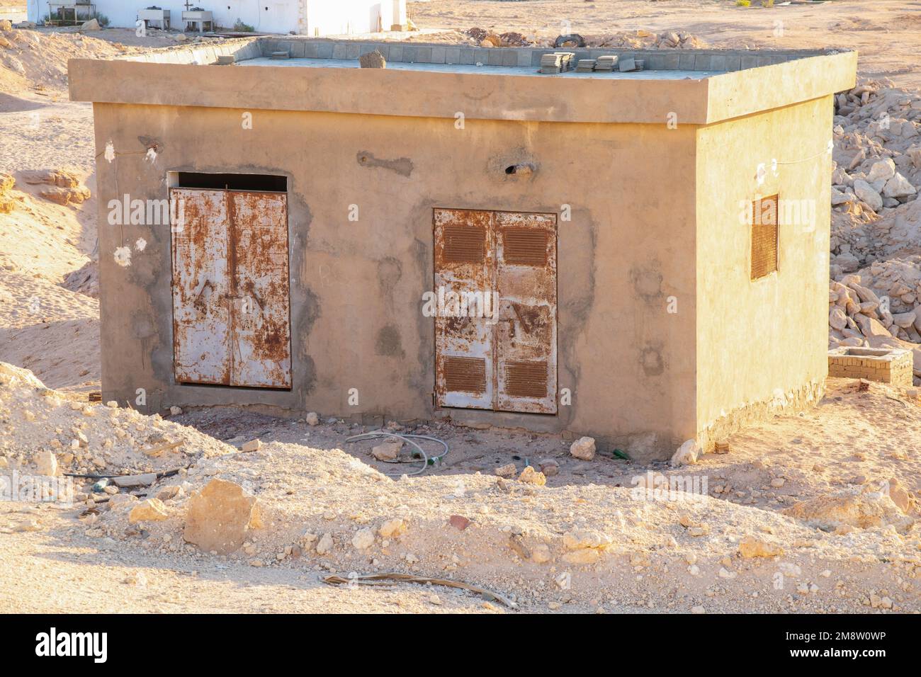 one-storey utility room stands on the sand in Egypt on a sunny day ...