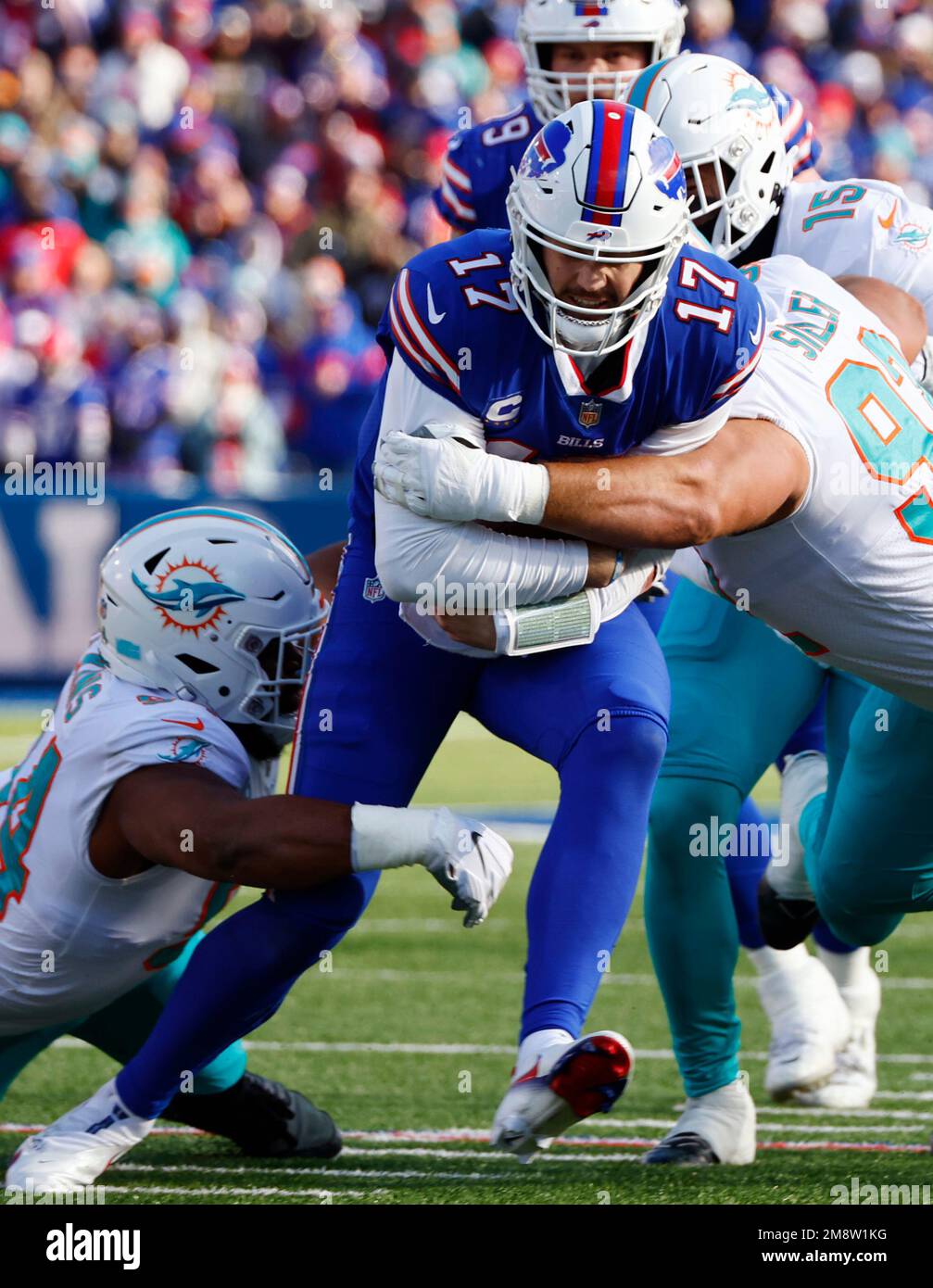 Buffalo Bills quarterback Josh Allen (17) is tackled by Miami Dolphins defense during the first ...
