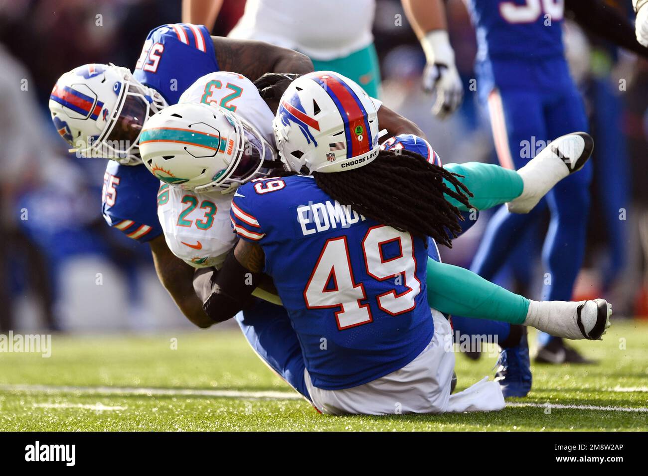 Miami Dolphins running back Jeff Wilson Jr. (23), center, is tackled by Buffalo Bills' Tremaine ...
