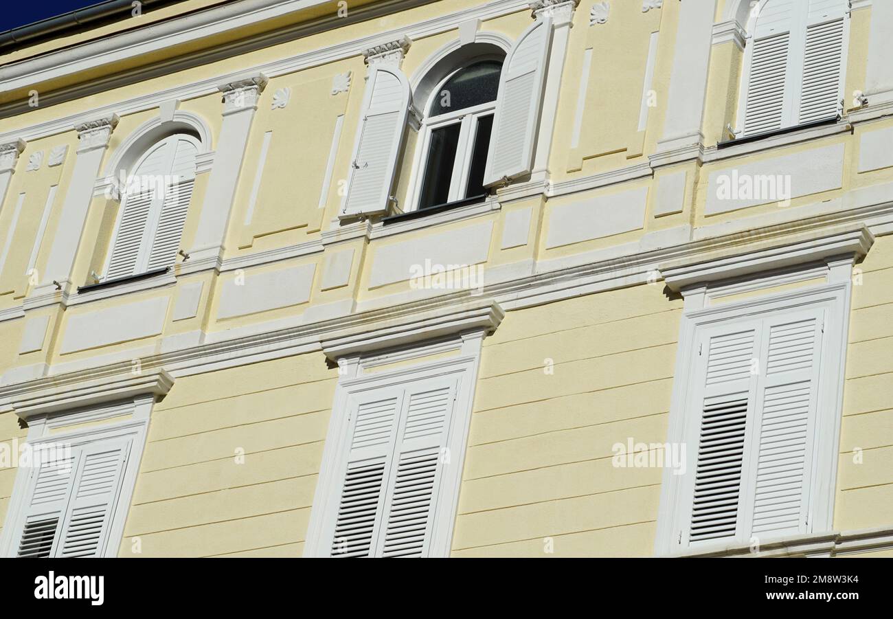 An open window on the top of a yellow building in the Art Nouveau style ...