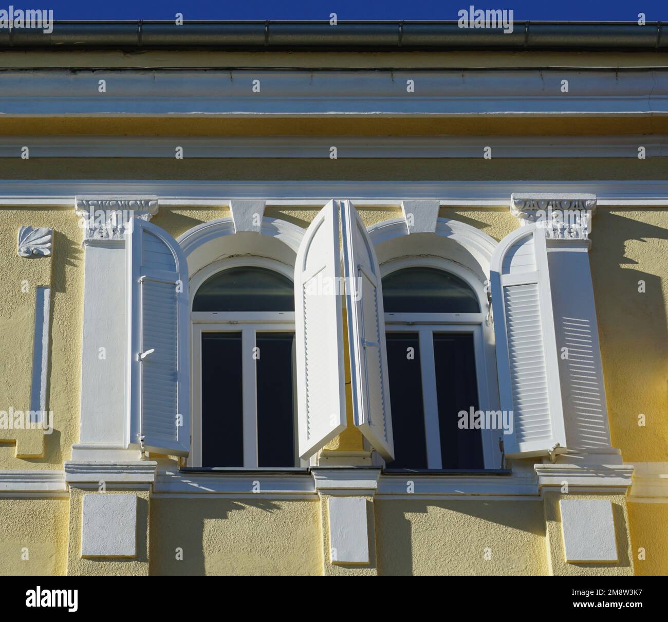 Art Nouveau semicircular windows on the yellow painted facade of the ...