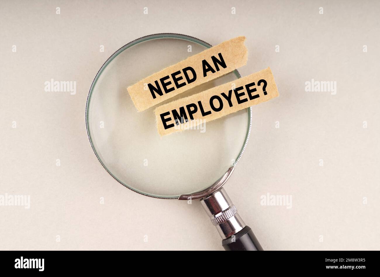 On the magnifying glass are paper strips with the inscription - Need an ...