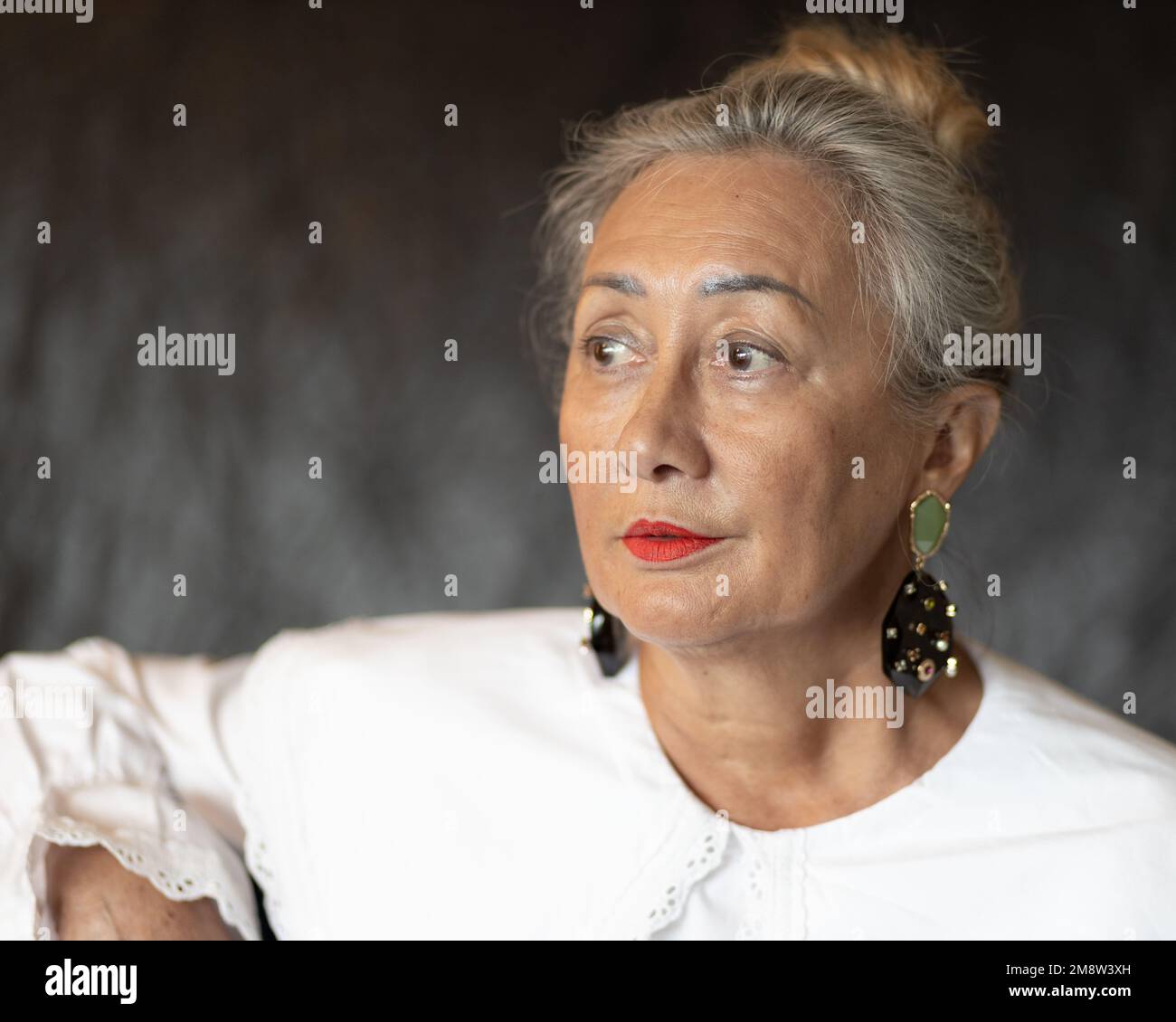 Studio portrait of a lady with raised hair and large earrings Stock ...
