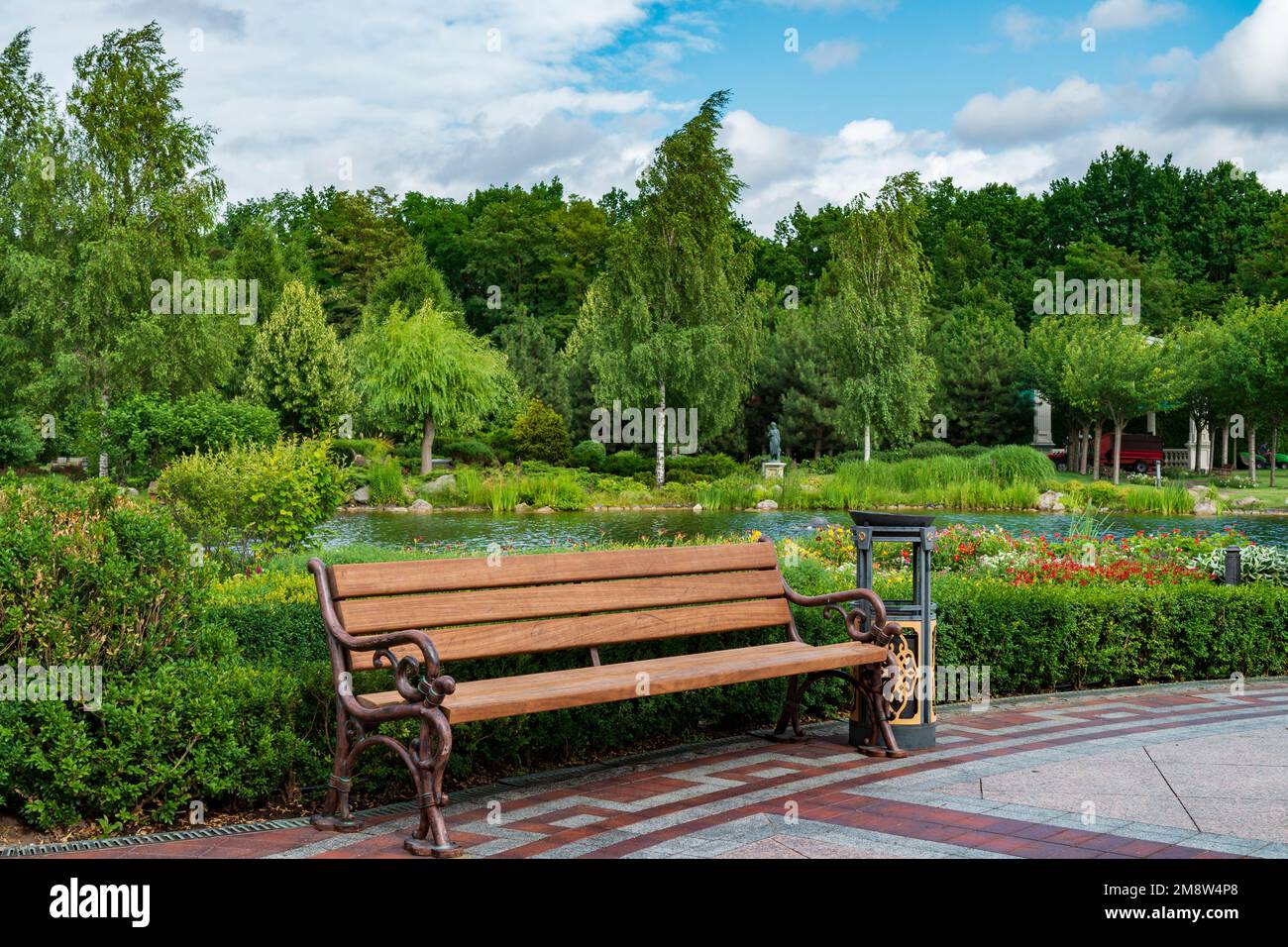 Beautiful summer park with bench. Tranquil place to rest and relax ...