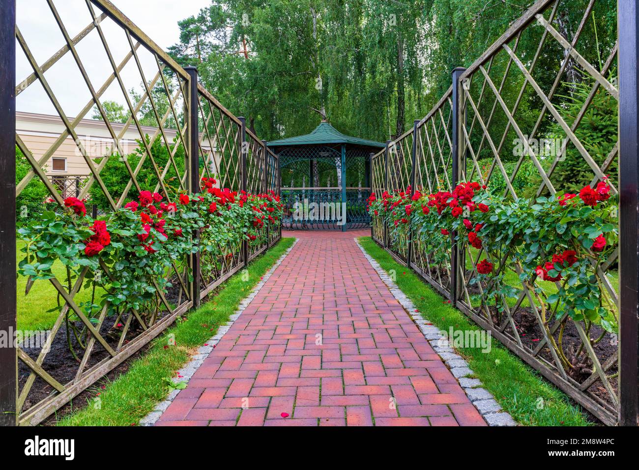 Beautiful rose garden with wooden gazebo Stock Photo - Alamy