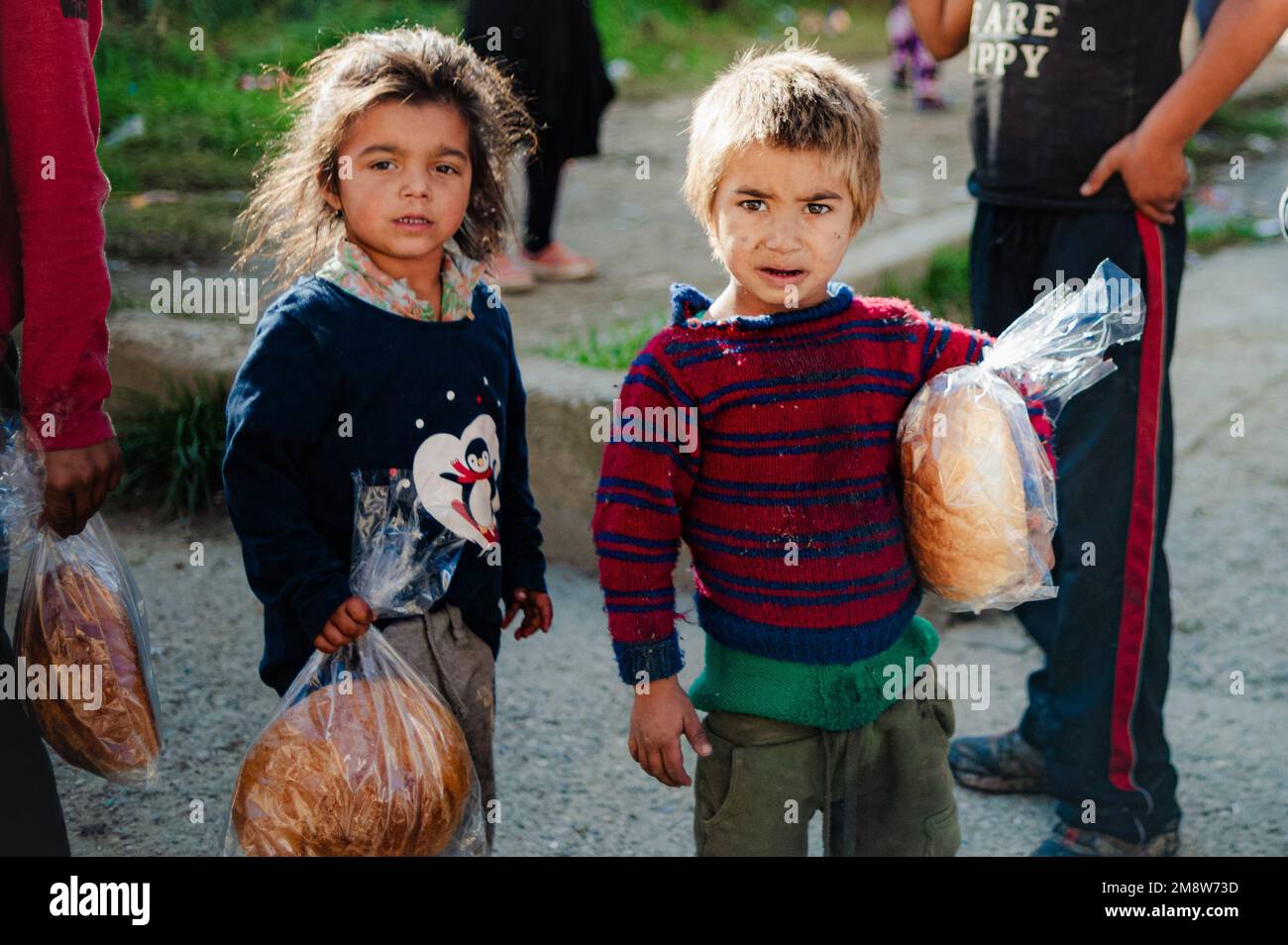 The poor little children in a Romanian hellhole holding breads in ...