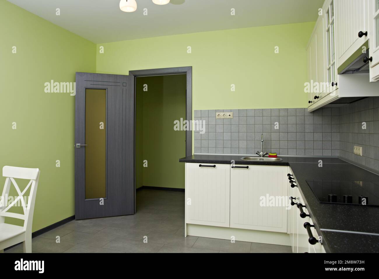 Kitchen room with exit. White wood kitchen unit Stock Photo - Alamy