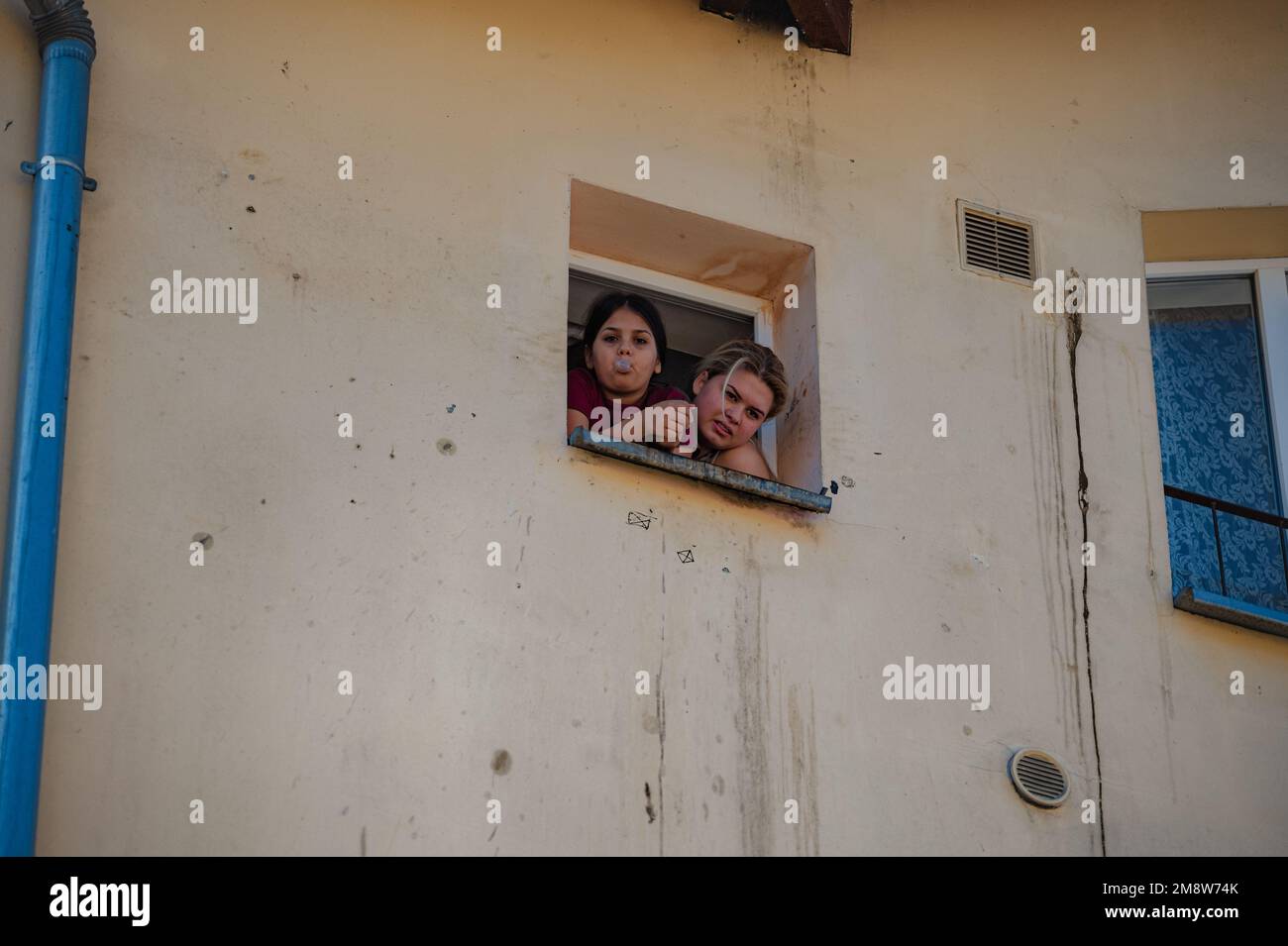 The poor people in a Romanian hellhole looking from the small window ...