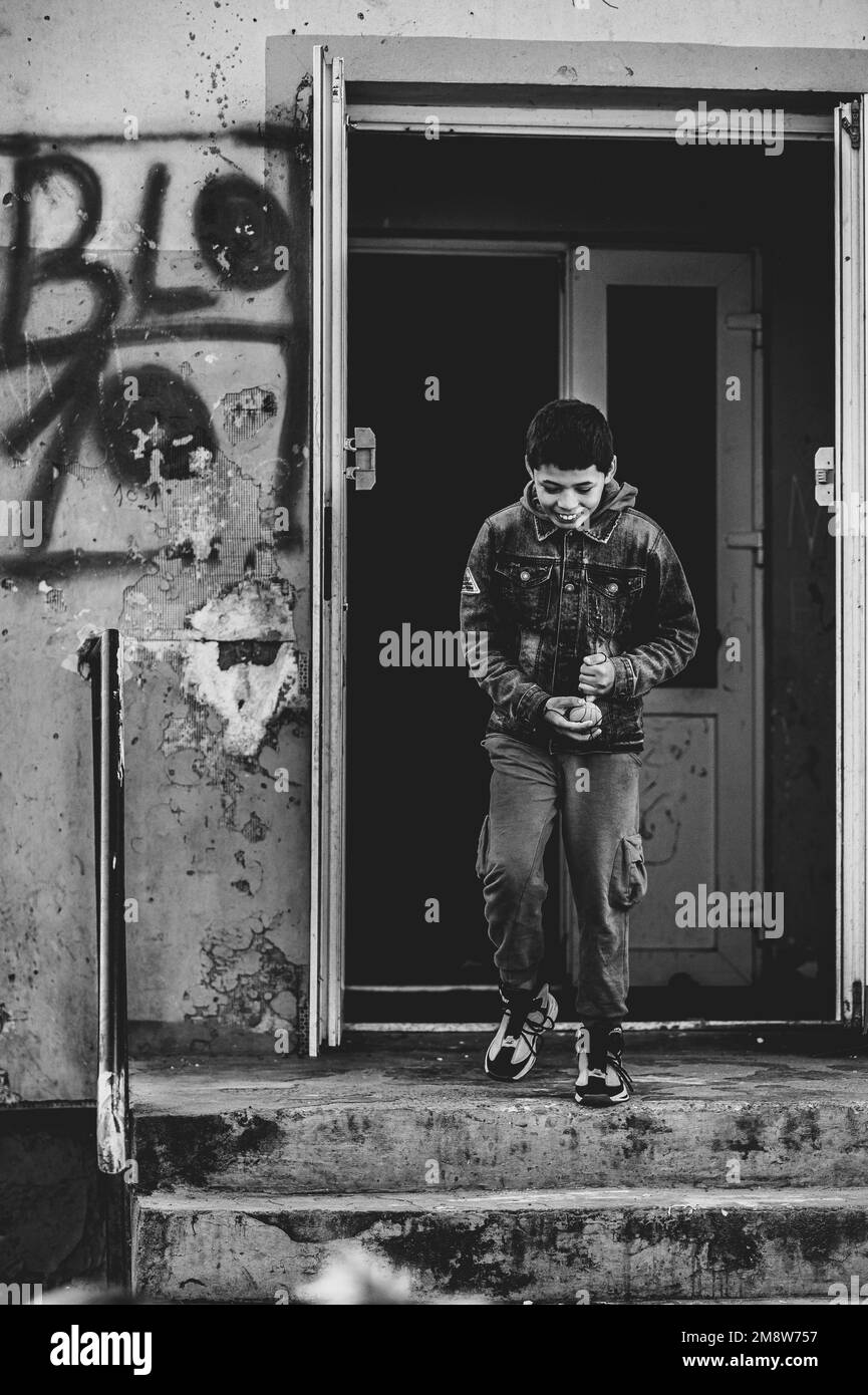 A monochrome shot of the poor teenage bot coming out of the terraced ...