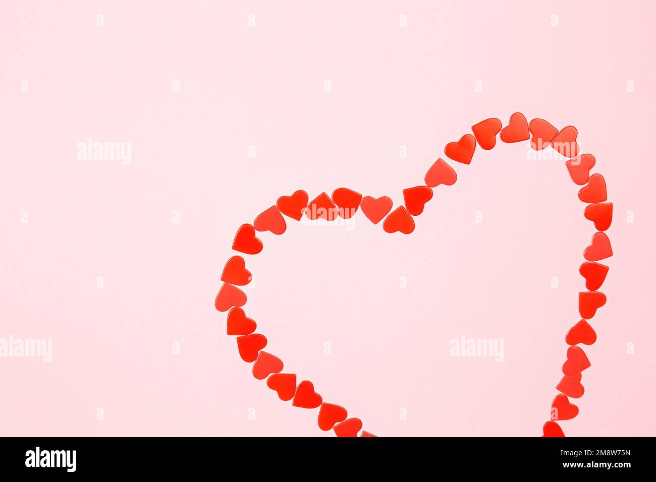 Pink background with red hearts in heart shaped form.Top view, empty ...
