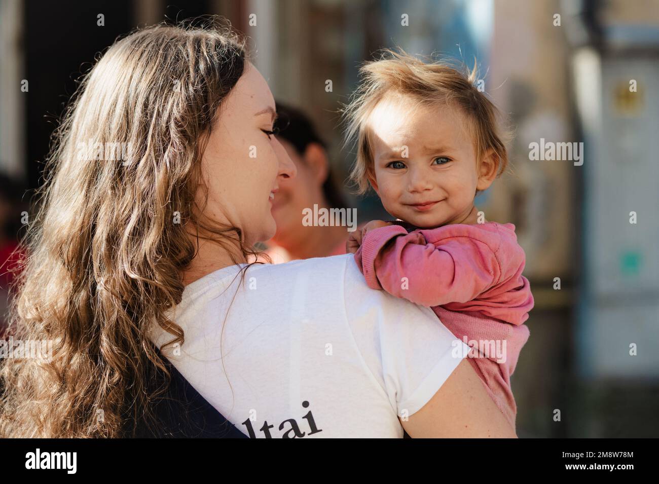 A poor cute little child in her mother's hug in a Romanian hellhole ...