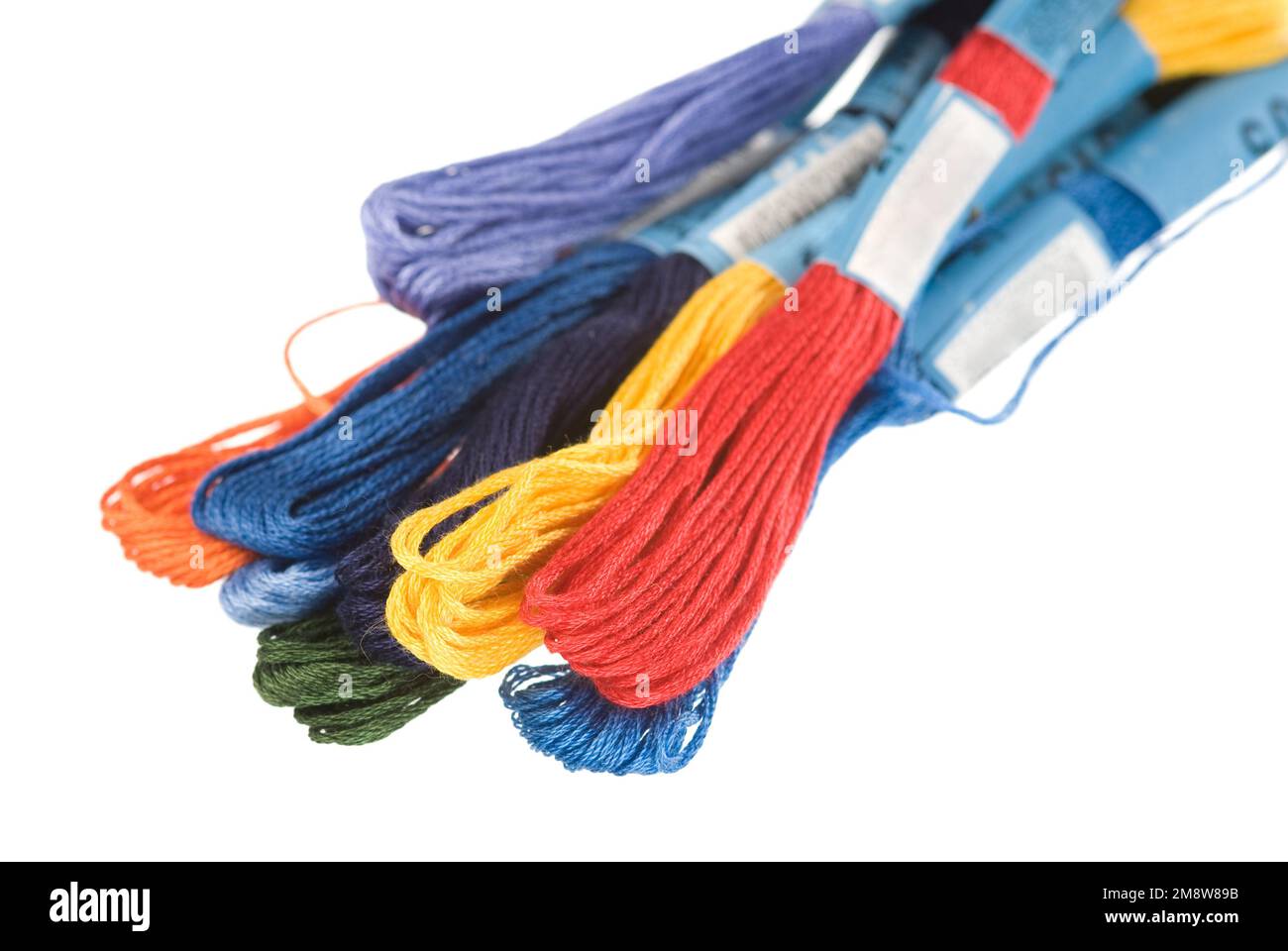 Different color embroidery threads isolated on white Stock Photo - Alamy