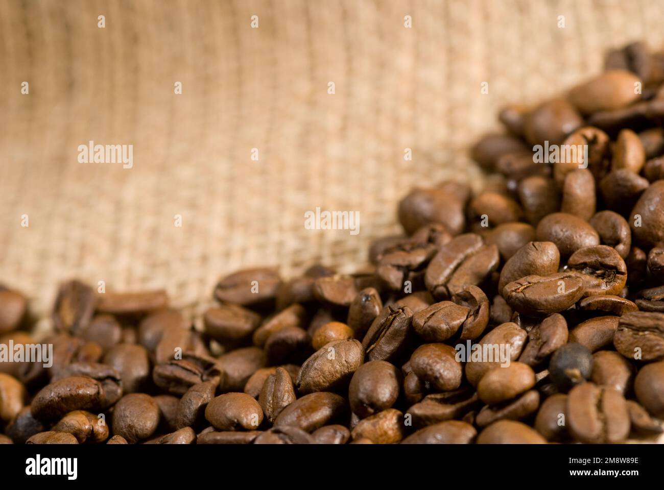 Roasted coffee beans on a sacking background Stock Photo - Alamy