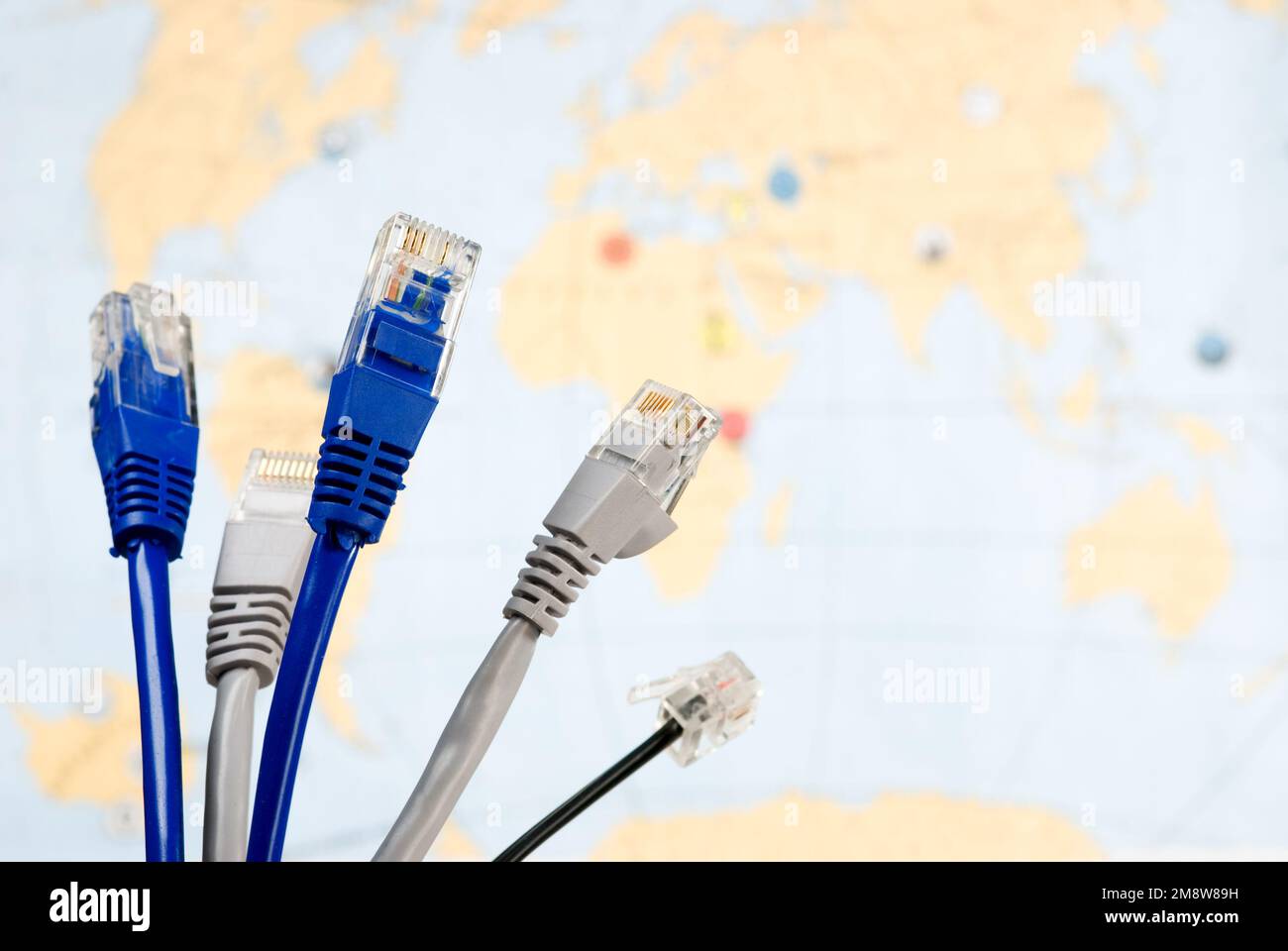 Network cables on the world map background Stock Photo - Alamy