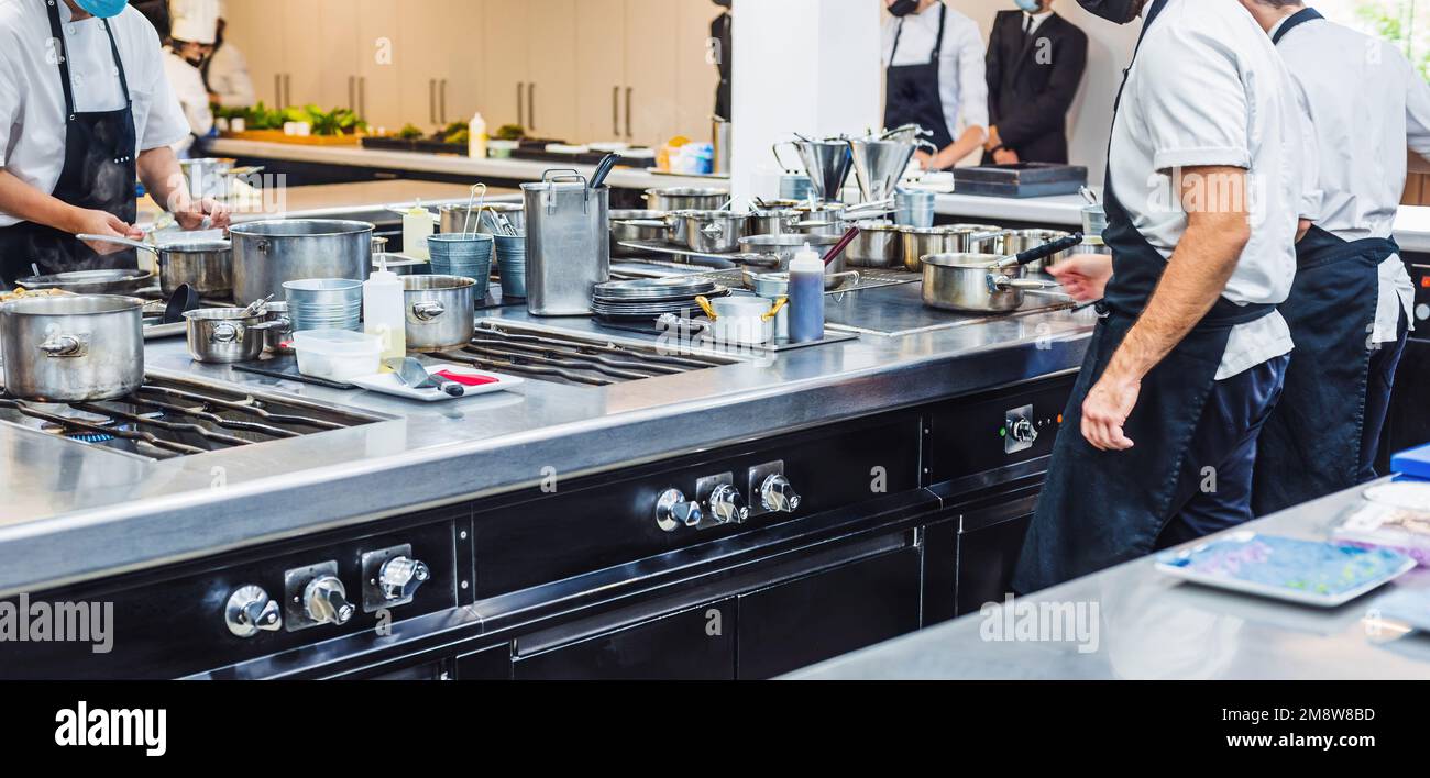 team of cooks working in the kitchen. haute cuisine concept Stock Photo ...