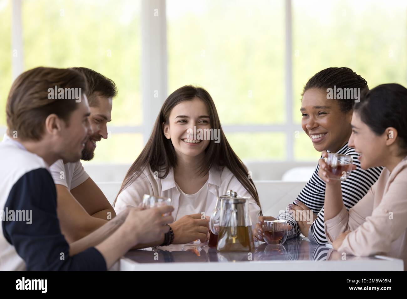 Multiethnic group friends chatting house hi-res stock photography and ...