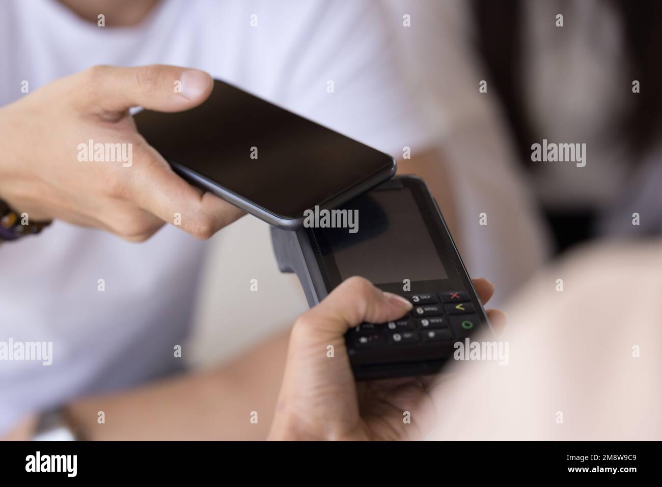 Male hand holding smartphone, applying camera to payment terminal Stock ...