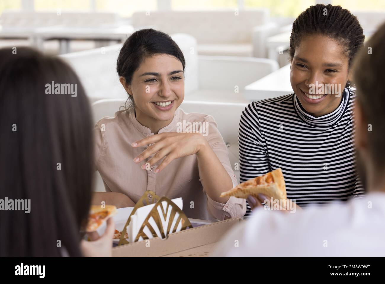 Indian group eating pizza hi-res stock photography and images - Alamy