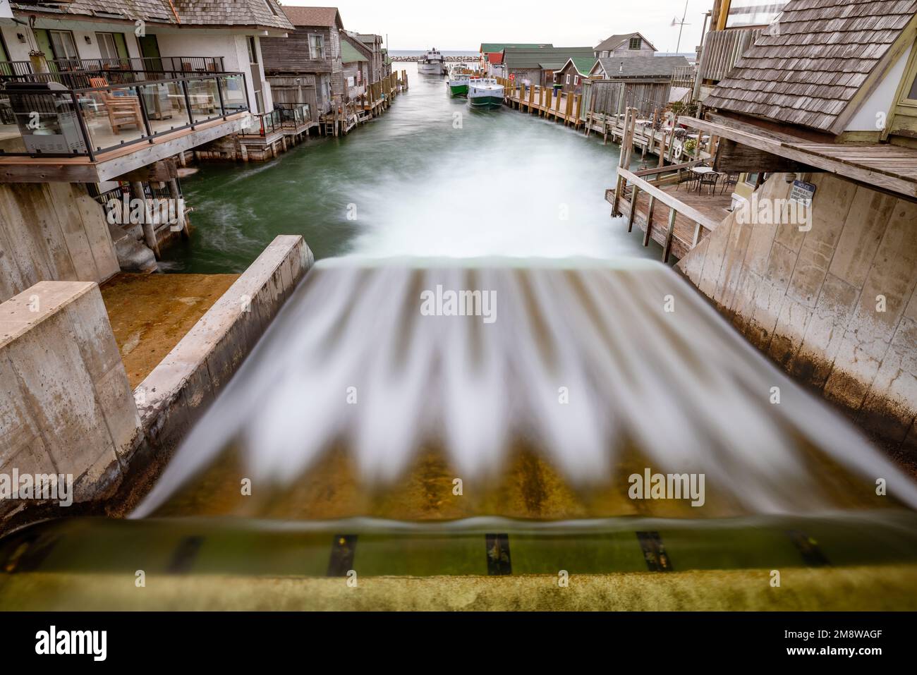 An image of falling water though the wooden buildings Stock Photo - Alamy