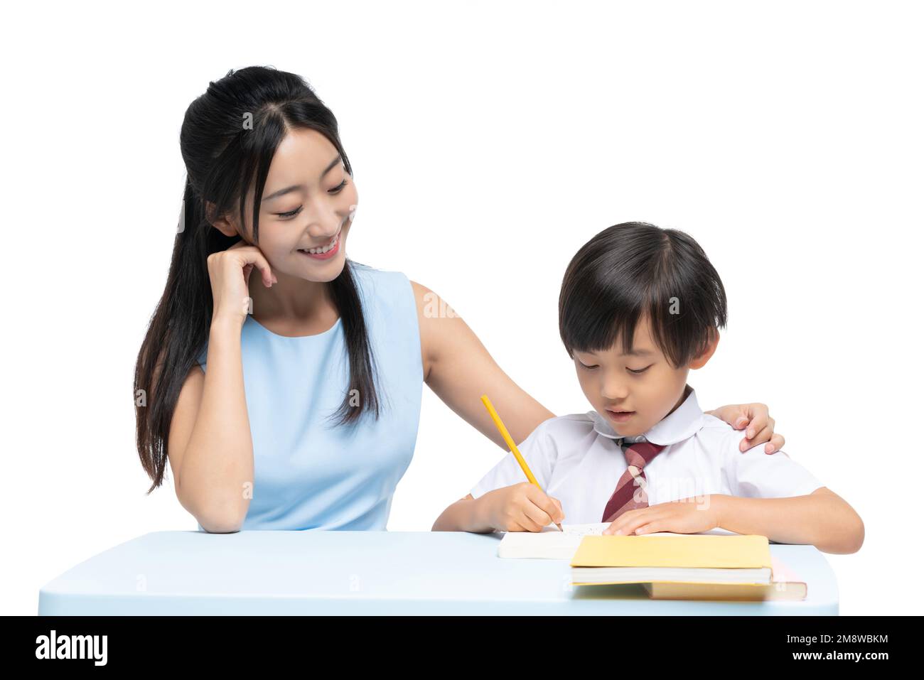 A young female teacher counseling boy learning Stock Photo - Alamy