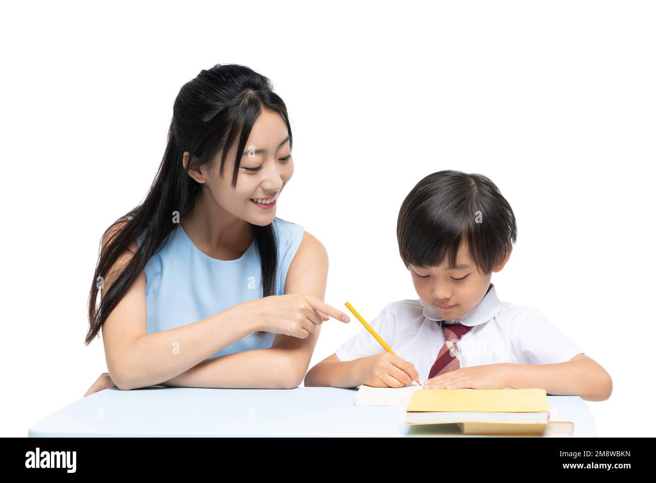 A young female teacher counseling boy learning Stock Photo - Alamy
