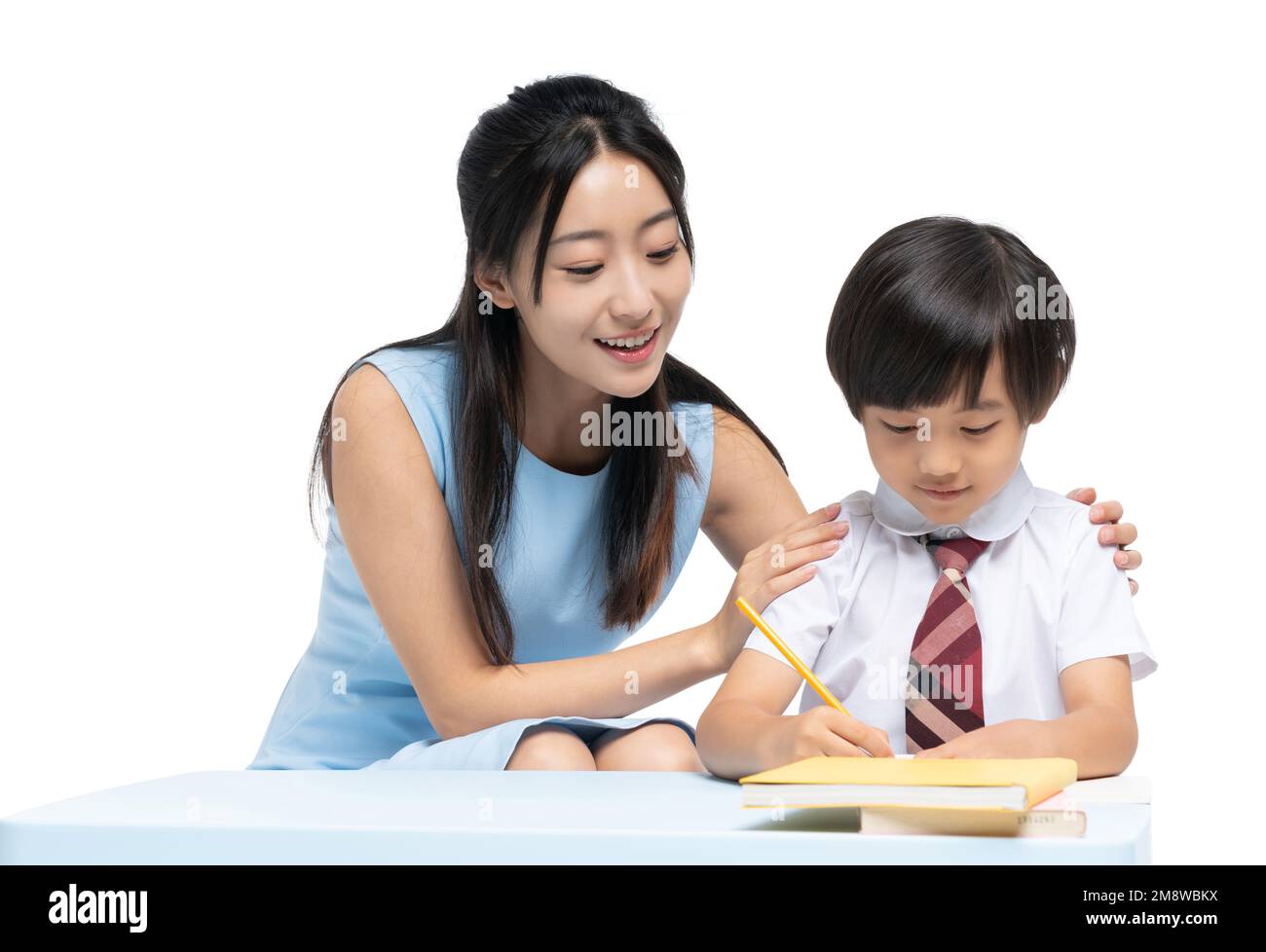 A young female teacher counseling boy learning Stock Photo - Alamy