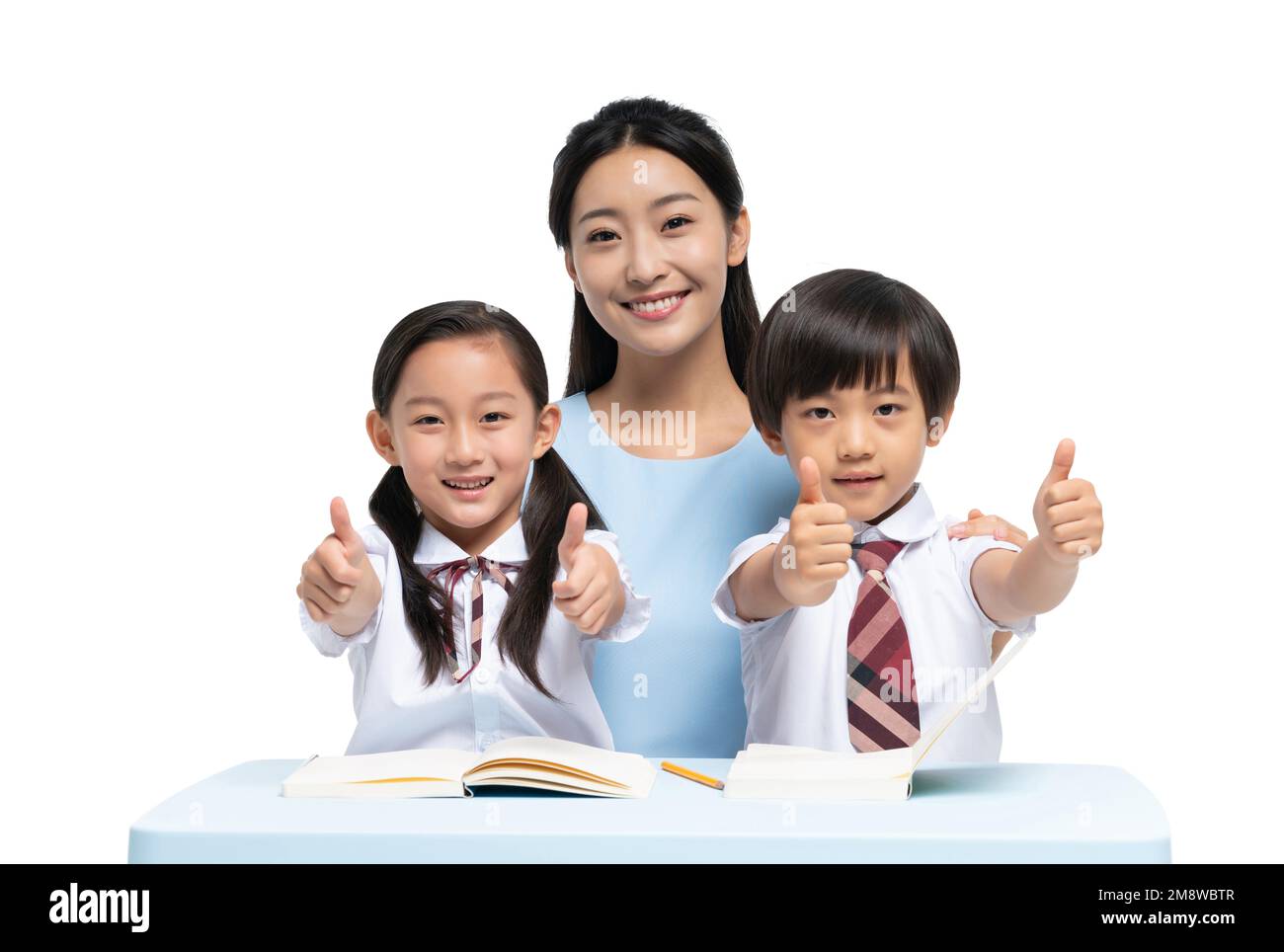 A young female teacher counseling students learning Stock Photo - Alamy