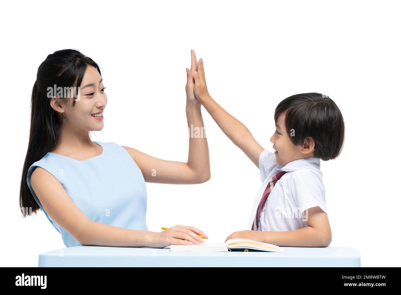A young female teacher counseling boy learning Stock Photo - Alamy