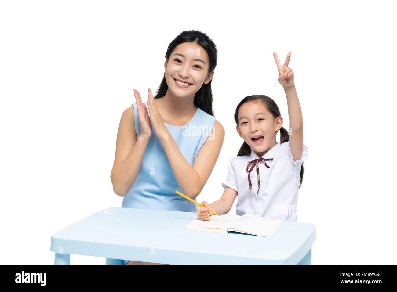 A young female teacher counseling students learning Stock Photo - Alamy