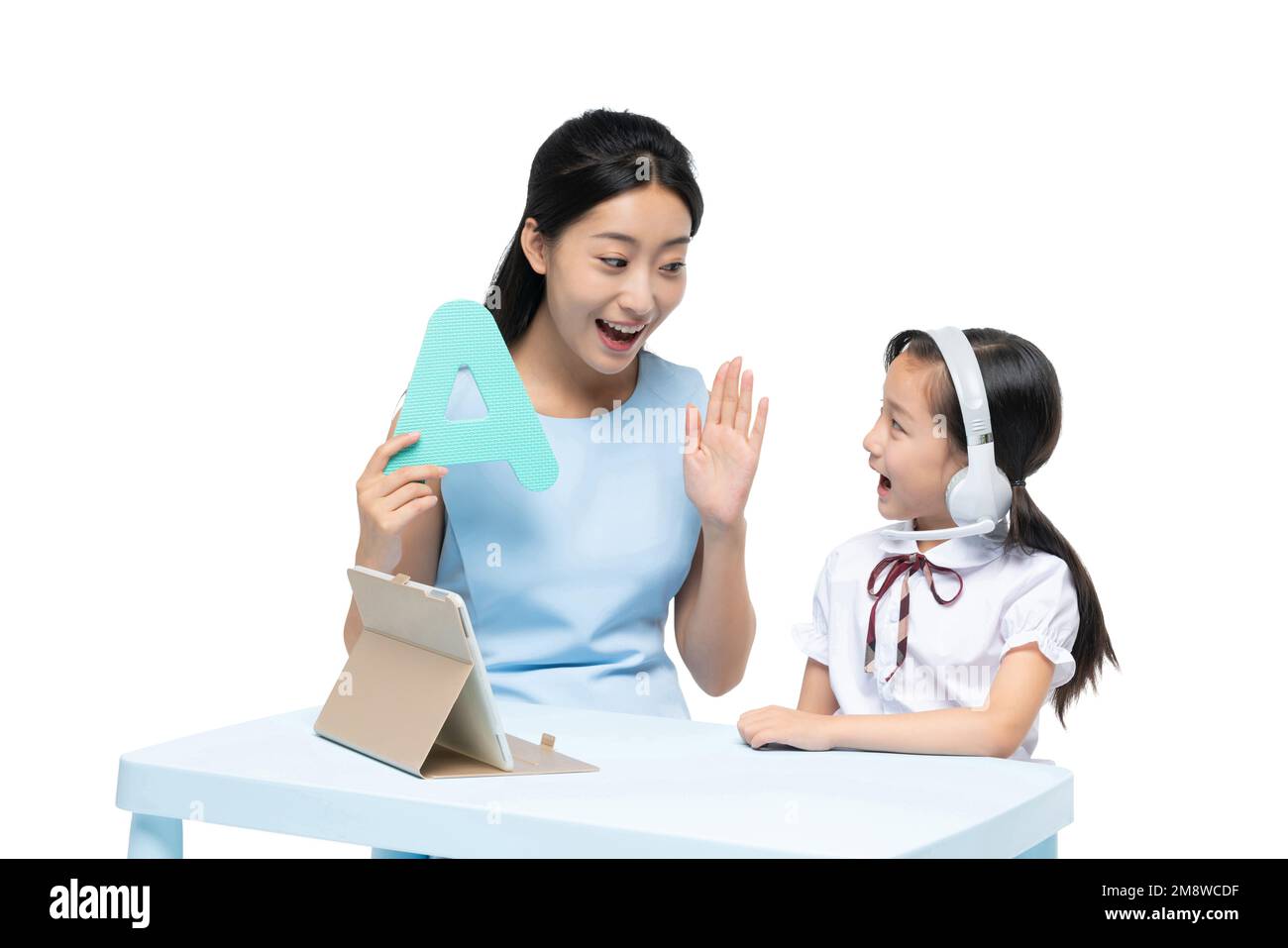A young female teacher counseling students learning Stock Photo - Alamy