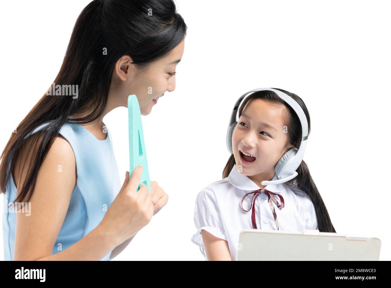 A young female teacher counseling students learning Stock Photo - Alamy