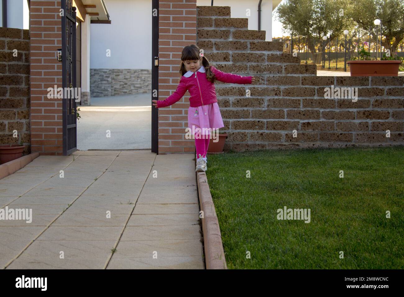 Image of an adorable little girl coming back from school playing ...