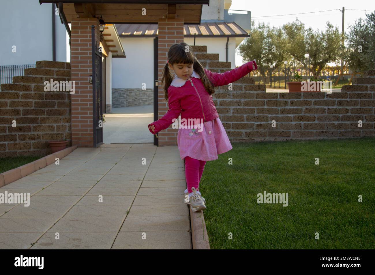 Image of an adorable little girl coming back from school playing ...