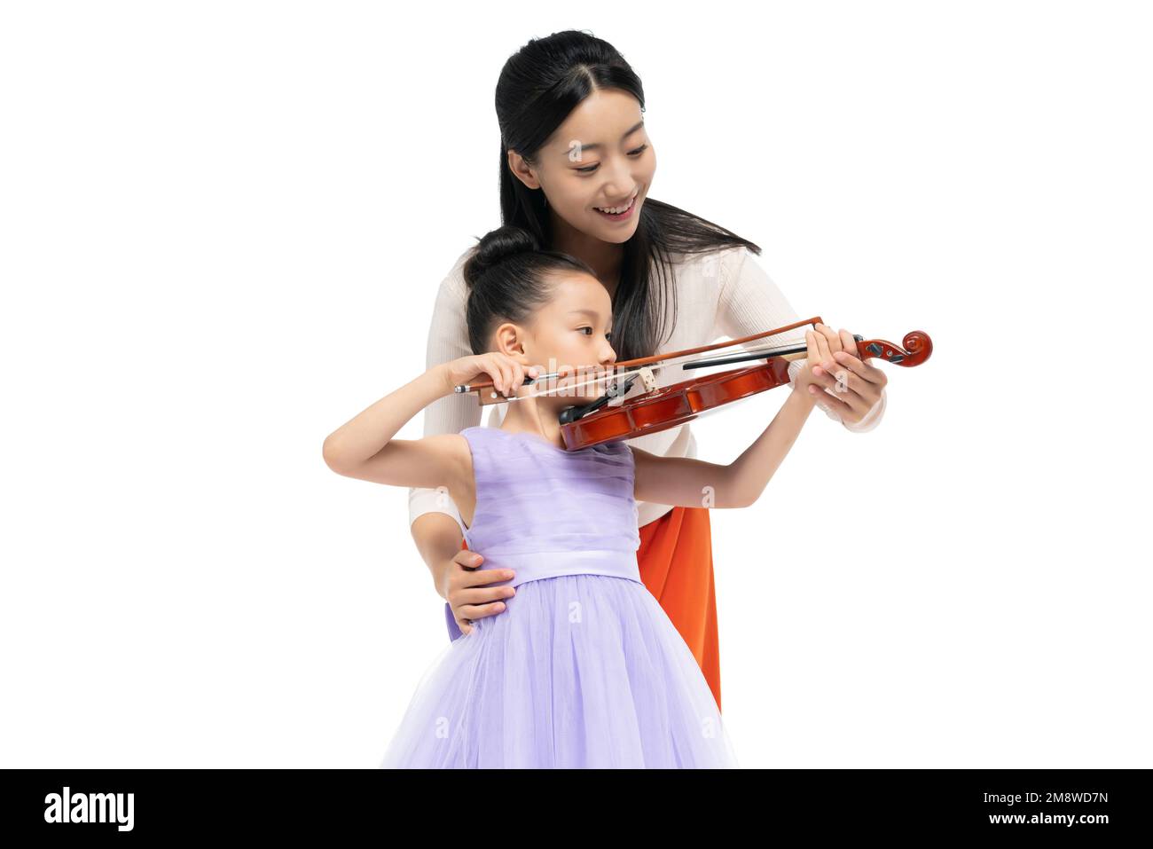 The female teacher guide girl playing Musical Instruments Stock Photo ...