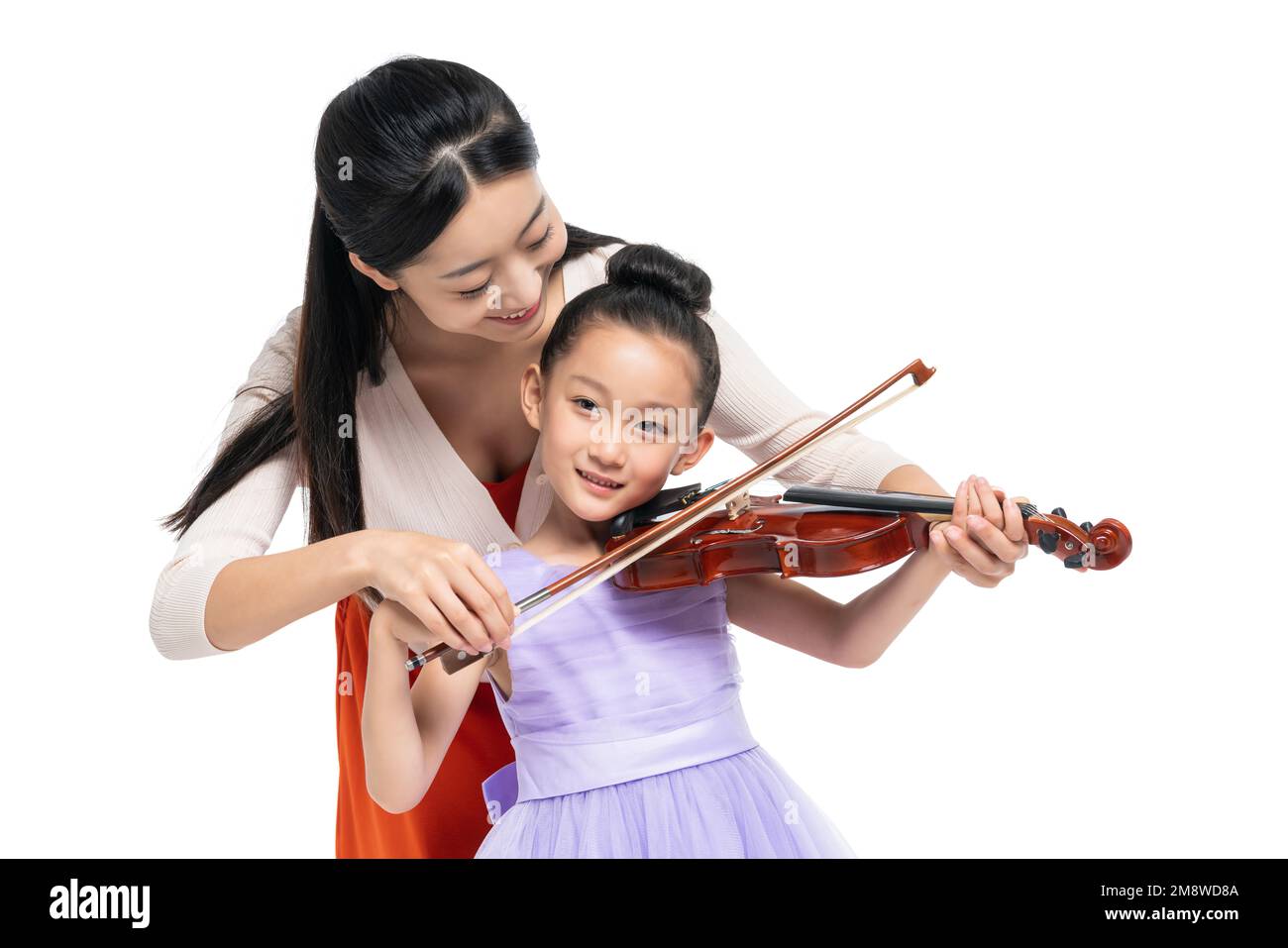 The female teacher guide girl playing Musical Instruments Stock Photo ...