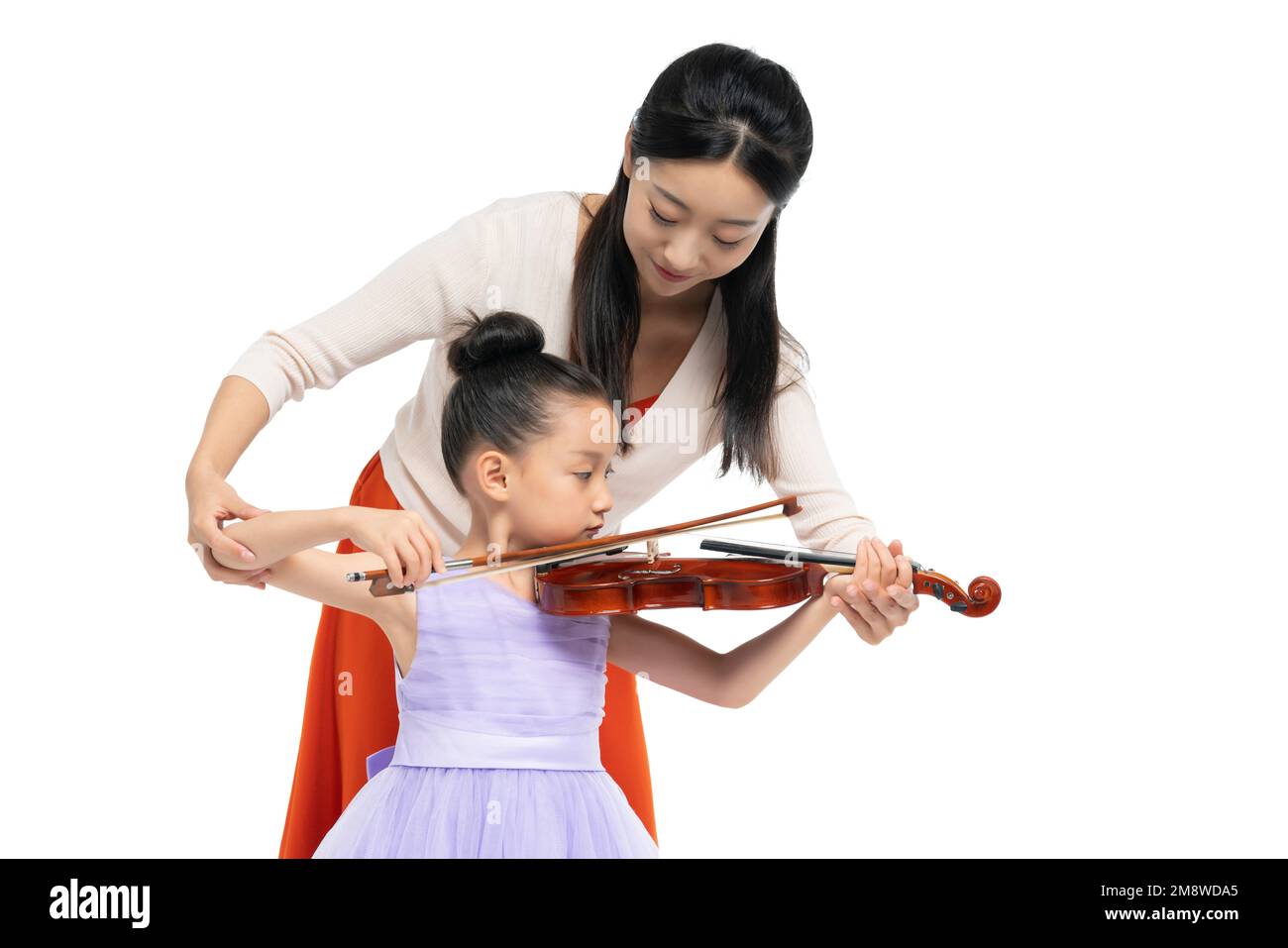 The female teacher guide girl playing Musical Instruments Stock Photo ...